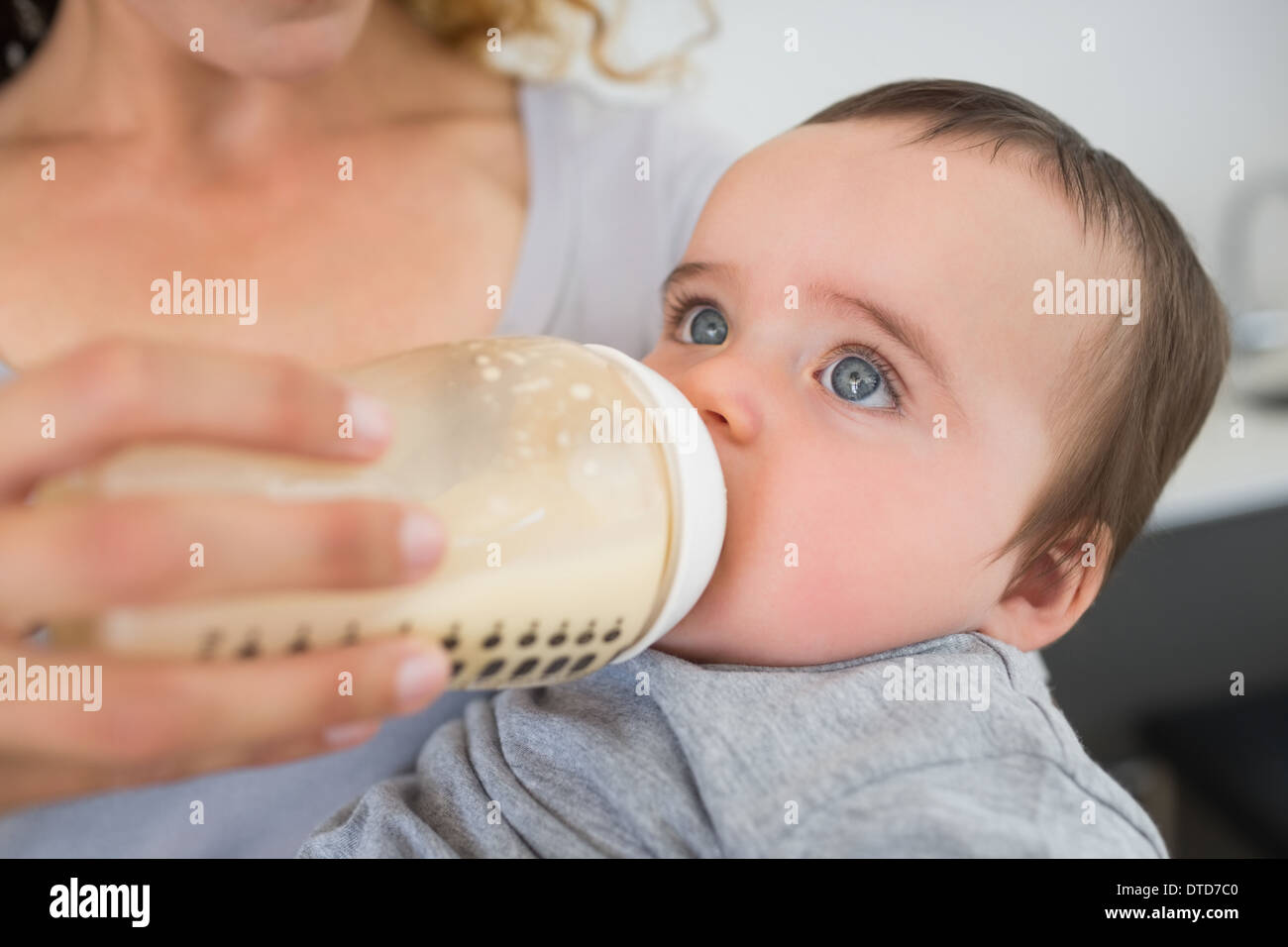 Mother feeding milk to baby Stock Photo - Alamy