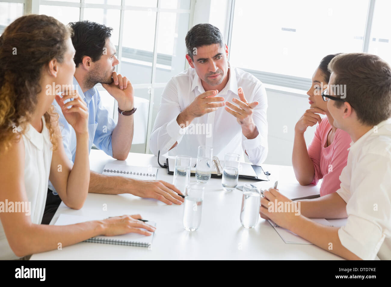 Sitting meeting communication listening table pointing hi-res stock ...