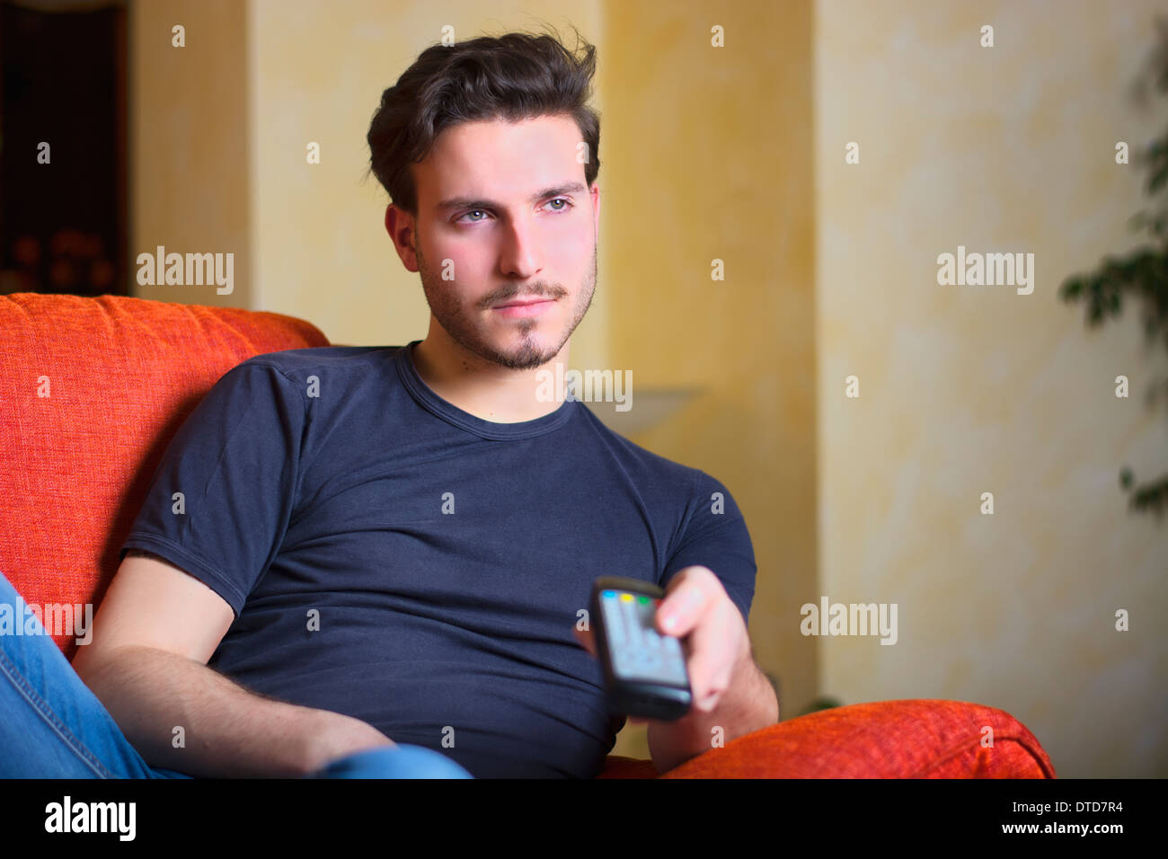 Person pointing remote at tv hi-res stock photography and images - Alamy