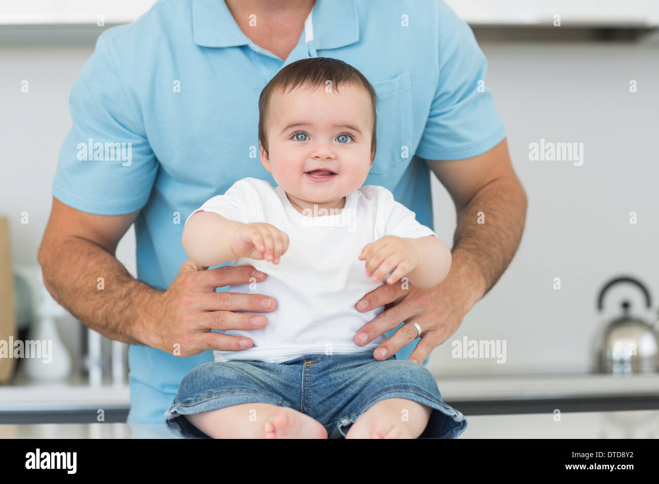 Adorable baby sitting on counter Stock Photo - Alamy
