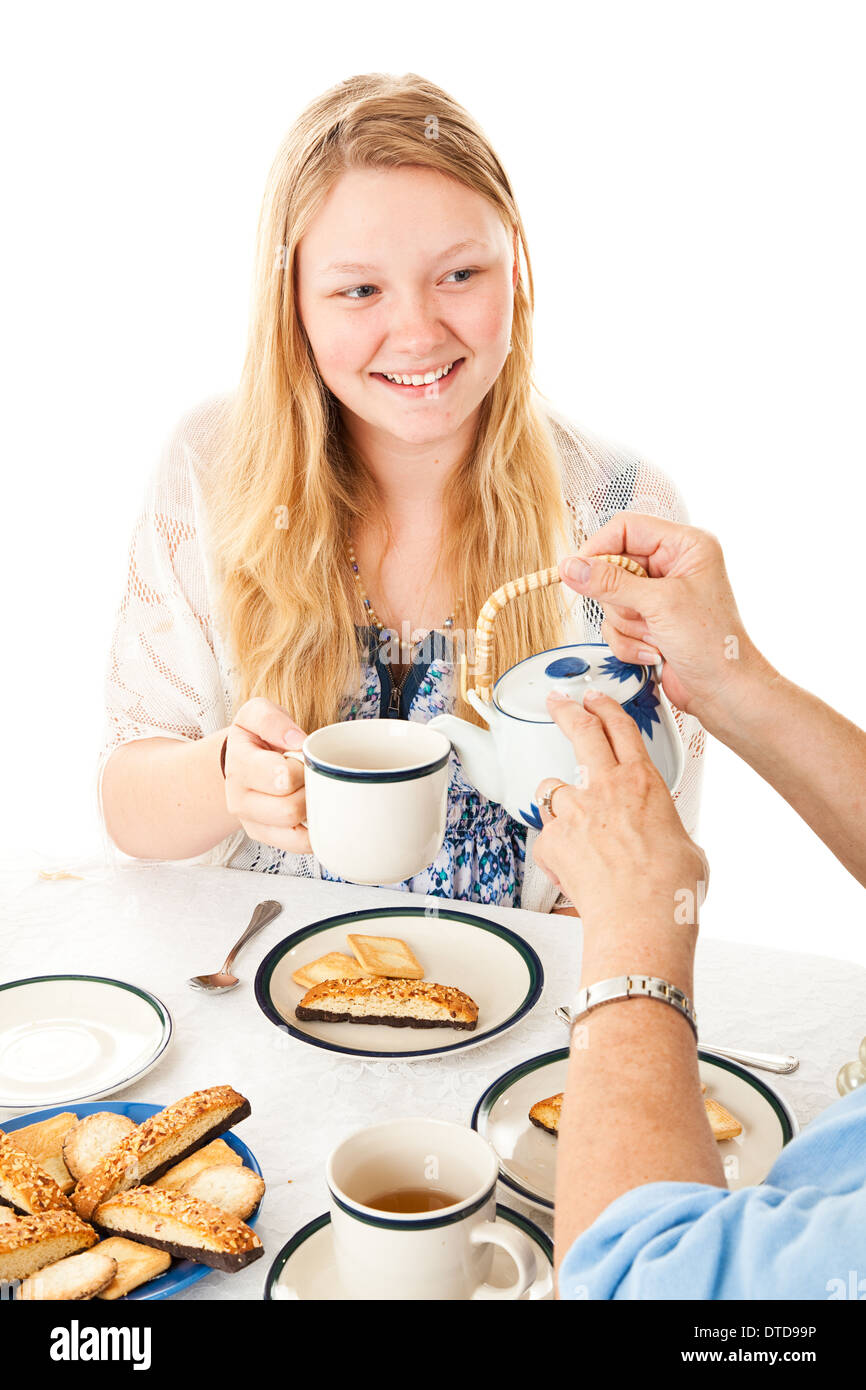 Beautiful blond teenage girl being served at a tea party. Isolated on ...