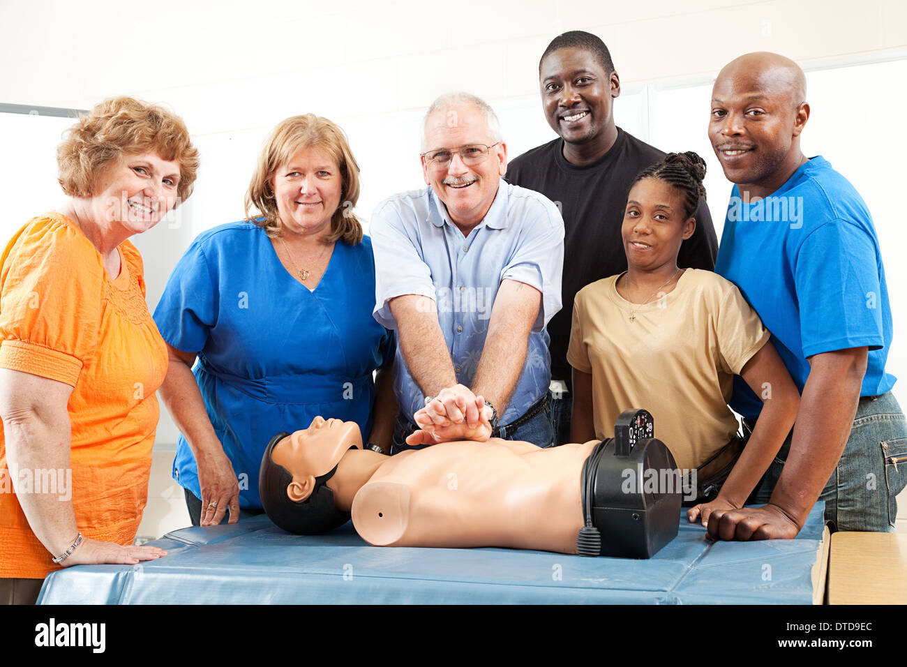 Adult education class on CPR and First Aid. Students and teacher with ...