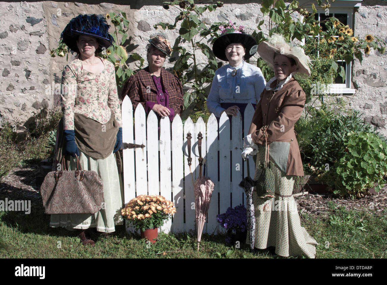 Four ladies posing in the summer garden Stock Photo - Alamy
