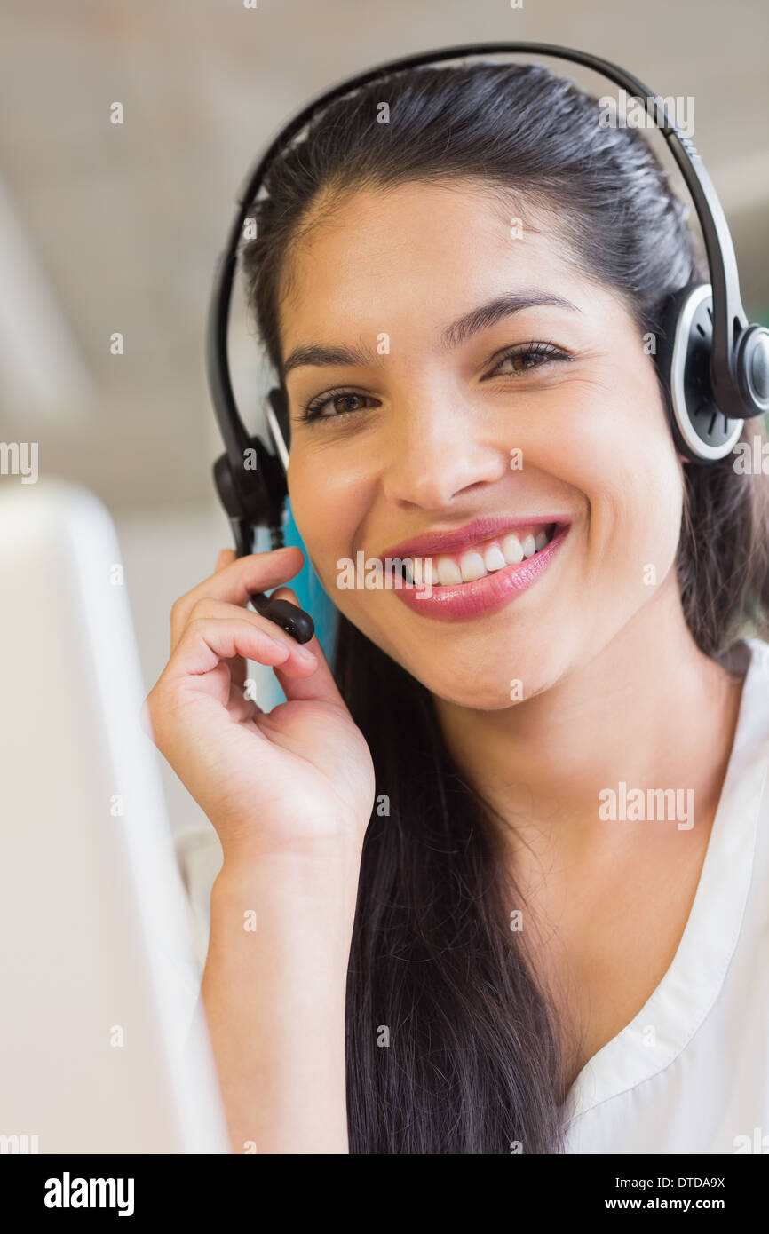 Smiling customer service representative wearing headset Stock Photo - Alamy