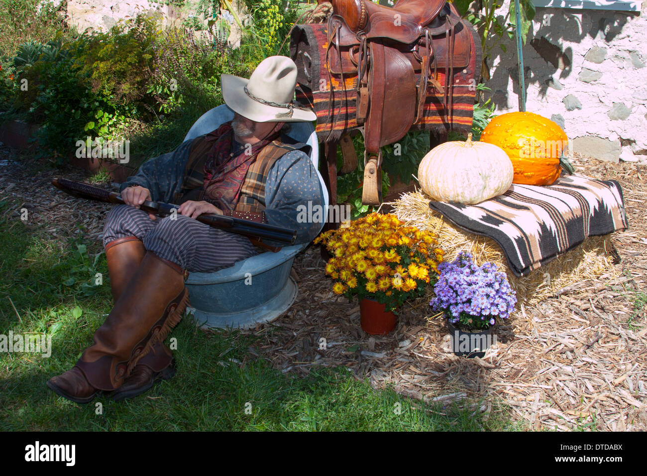 A cowboy sleeping in an old tub Stock Photo - Alamy