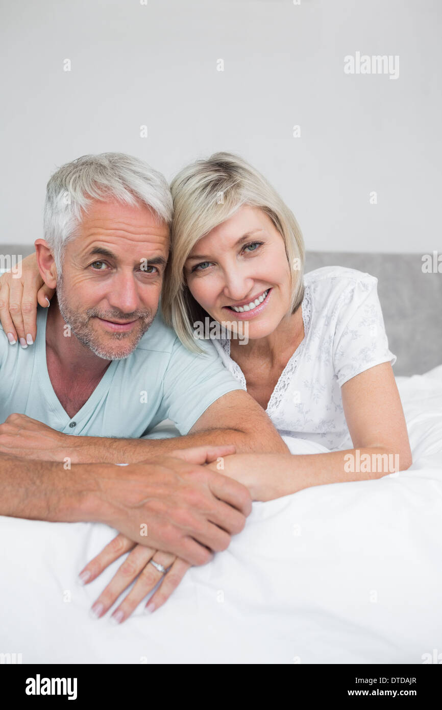 Portrait of a mature couple lying in bed Stock Photo - Alamy