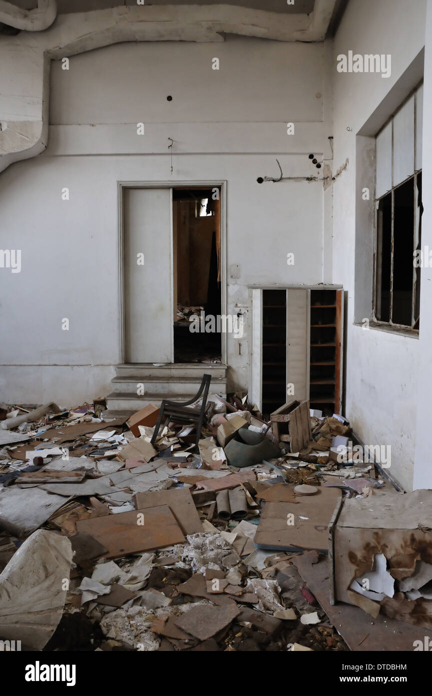 Vandalized room debris on the floor of abandoned building interior ...