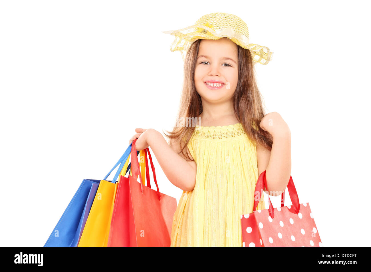 Cute girl in fancy clothes holding shopping bags Stock Photo - Alamy