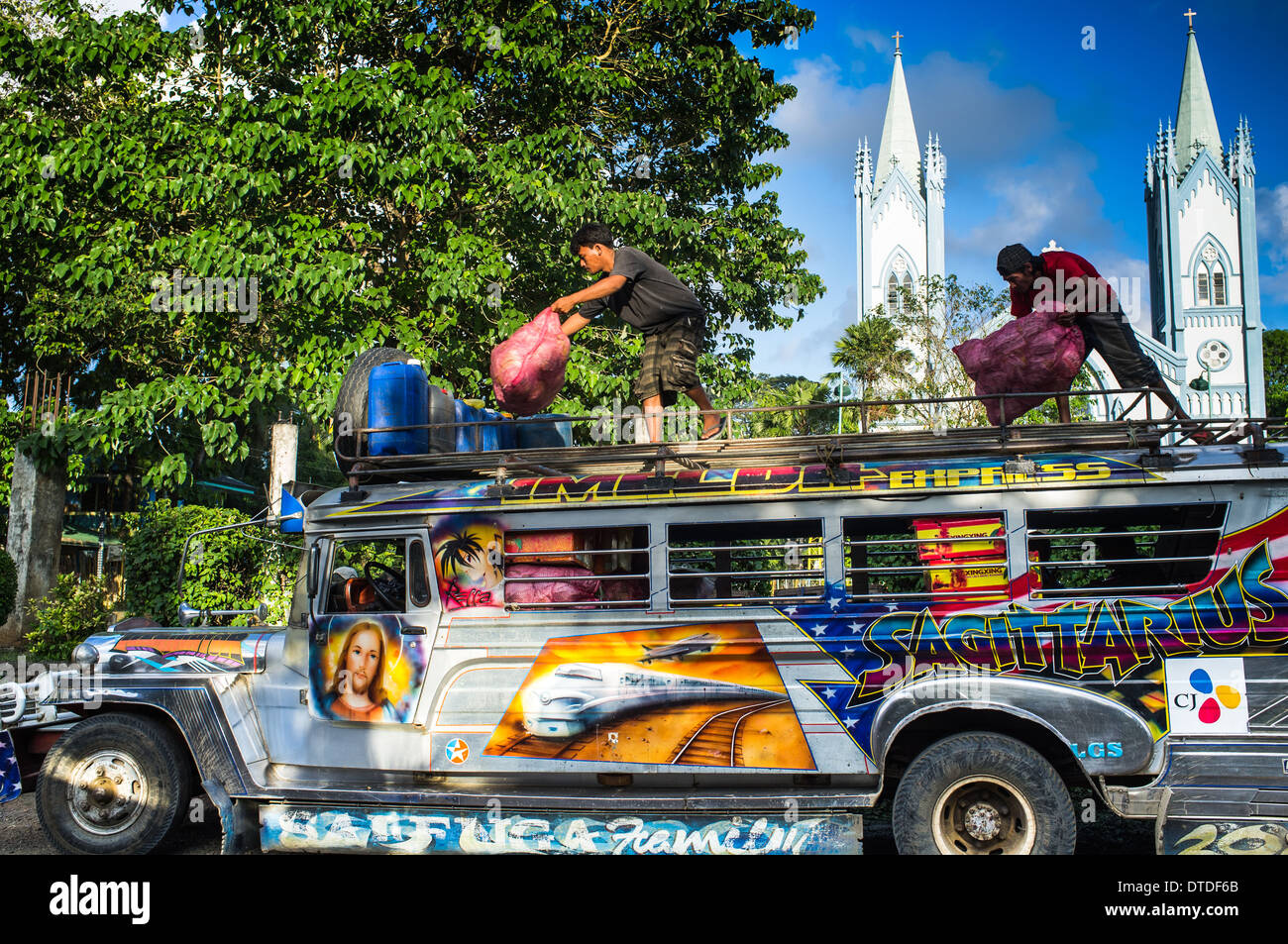 Colorful jeepney loading up, background church, Puerto Princesa ...