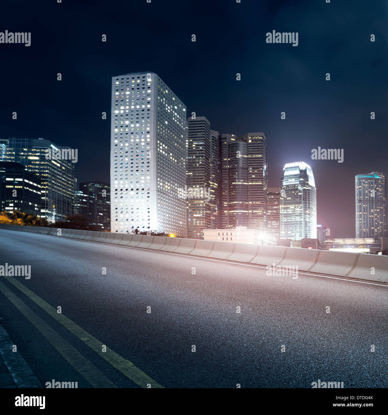 Highway and city at night Stock Photo - Alamy