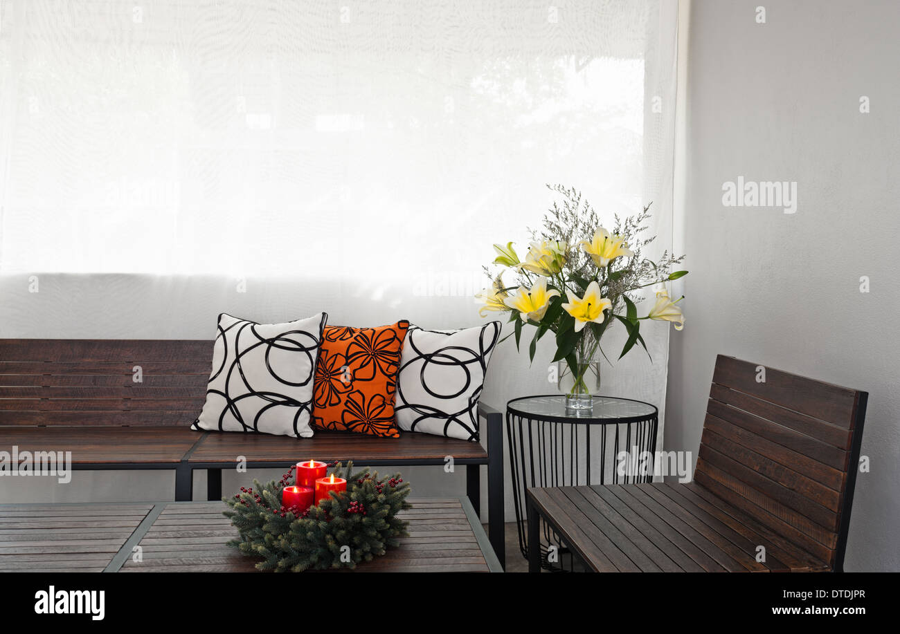 Patio lounge with garden bench and flower decoration Stock Photo - Alamy