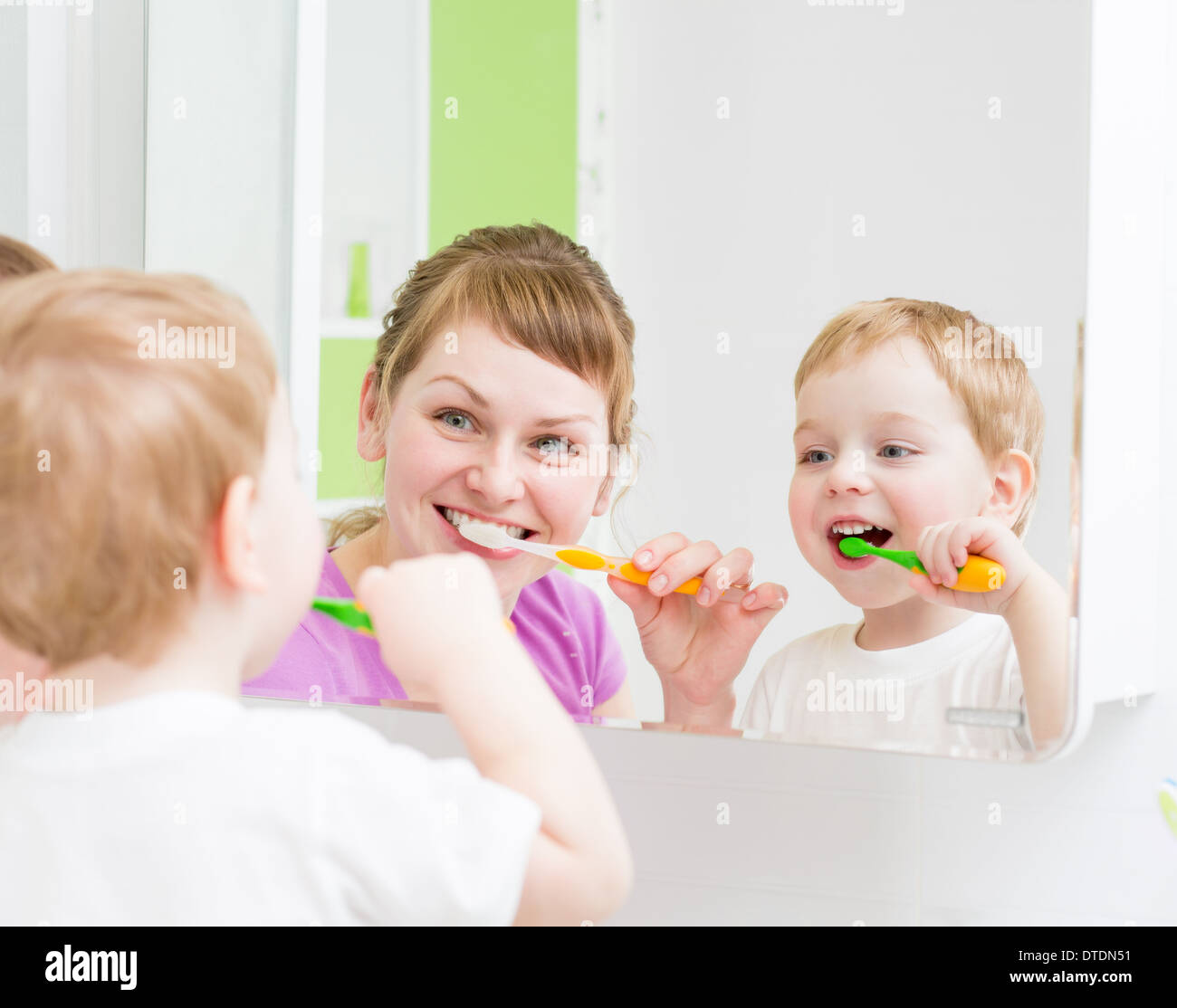 Happy family brushing teeth together hi-res stock photography and ...