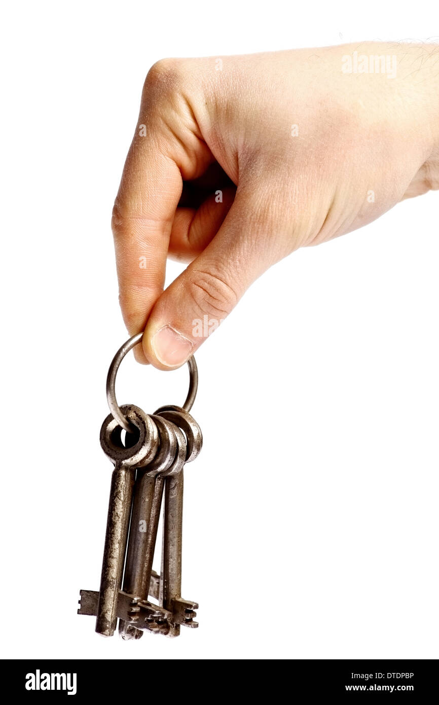 Hand holding a bunch of old and rusty keys on a ring isolated on white ...