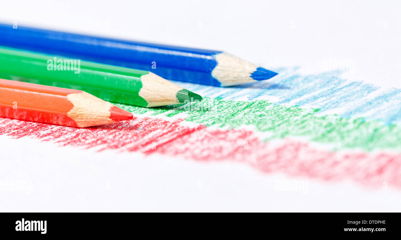 RGB pencils and abstract lines of red, green and blue color on textured ...