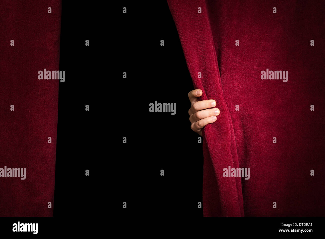Hand appearing beneath the curtain. Red curtain Stock Photo - Alamy