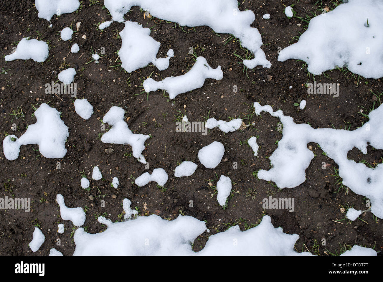 Melting snow is showing land. Spring time Stock Photo - Alamy