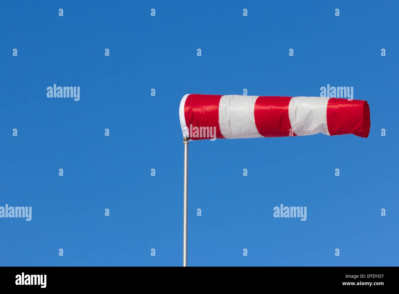 Airfield wind cone at mast, blue sky background Stock Photo - Alamy