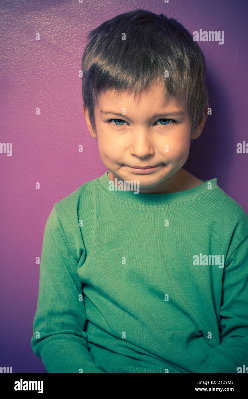 Young boy indoors looking at camera Stock Photo - Alamy