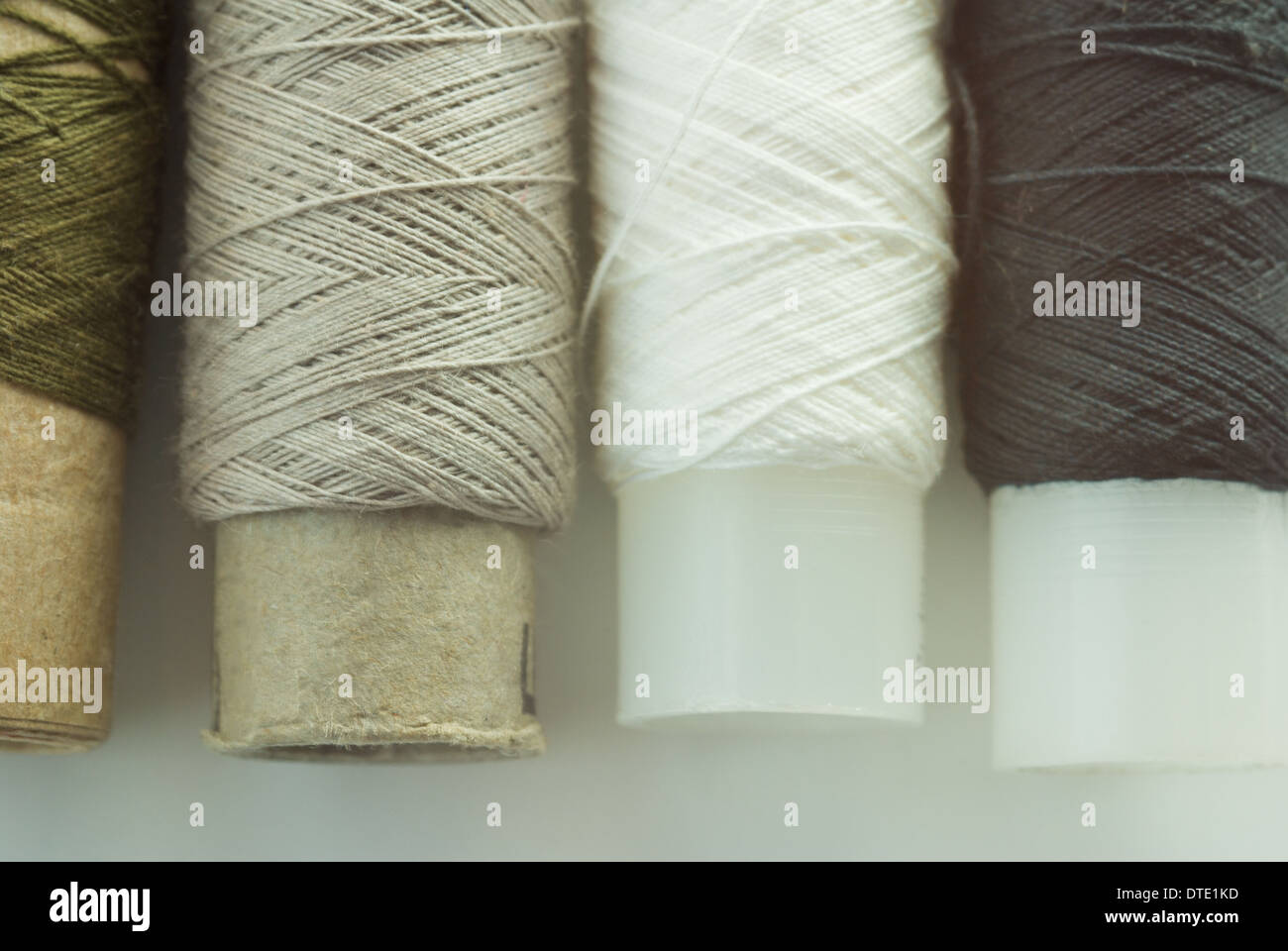 spool of thread in four colors Stock Photo - Alamy