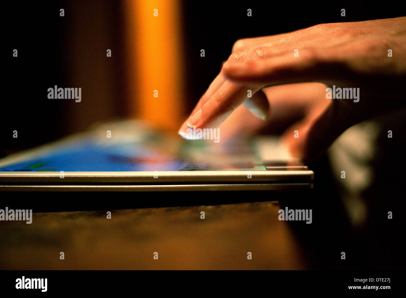 Hand touching a computer screen Stock Photo - Alamy