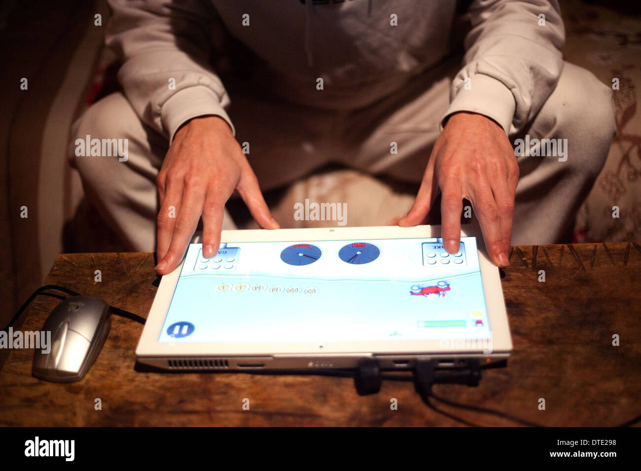 teenager playing a computer Stock Photo - Alamy