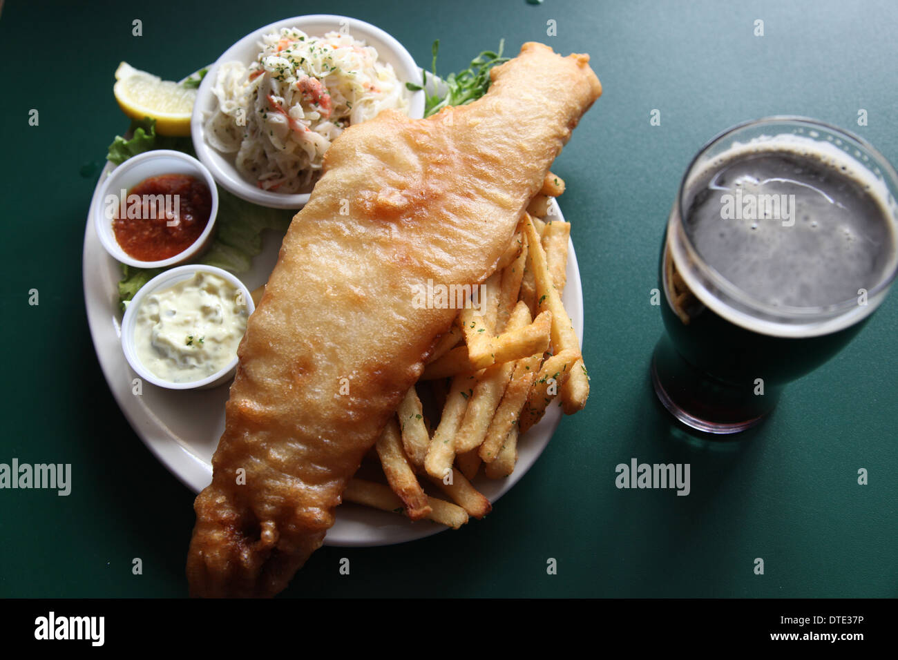 Fish & Chips with a pint of stout beer Stock Photo - Alamy