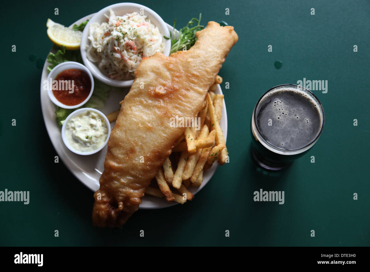 Fish & Chips with a pint of stout beer Stock Photo - Alamy