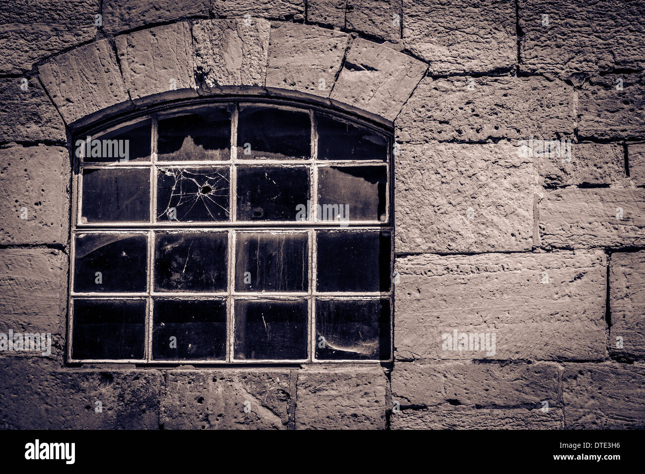 Ancient window in a stone cottage with a bullet hole in the glass Stock ...