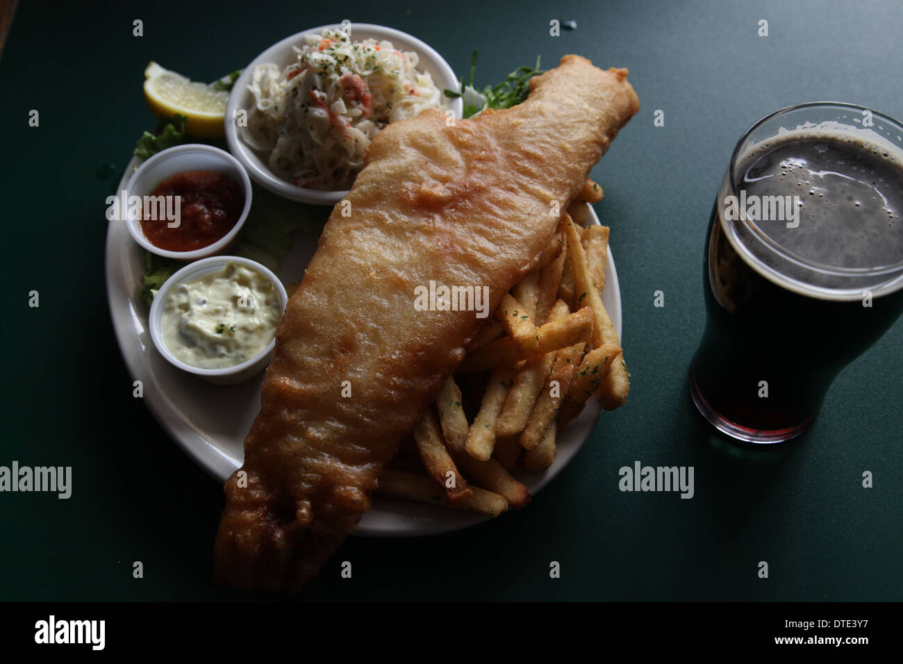 Fish & Chips with a pint of stout beer Stock Photo - Alamy