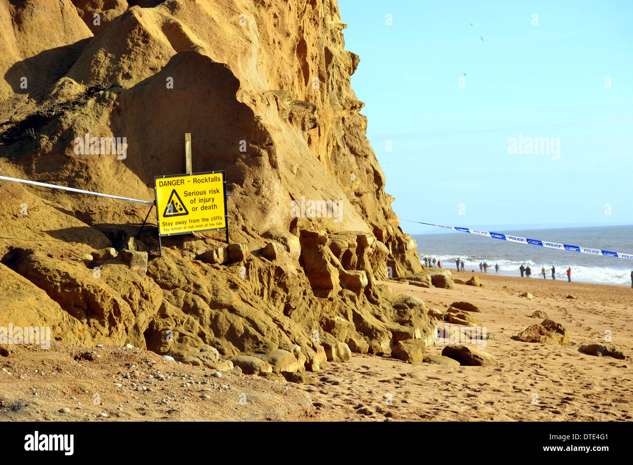 People ignore danger signs to walk on the beach at West Bay, Dorset ...