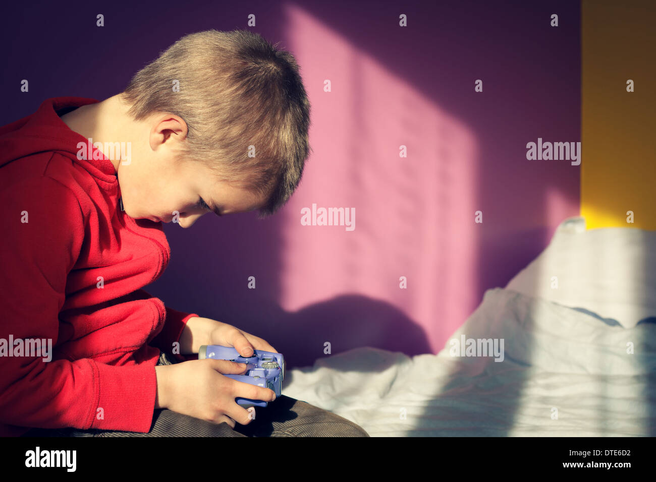 Boy (6-7) playing game Stock Photo - Alamy