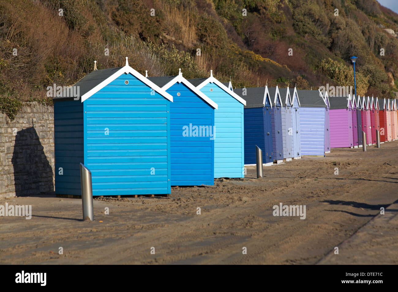 dislodged blue and purple beach huts facing the wrong way and out of ...