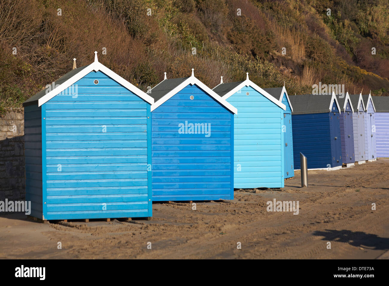 dislodged blue and purple beach huts facing the wrong way and out of ...