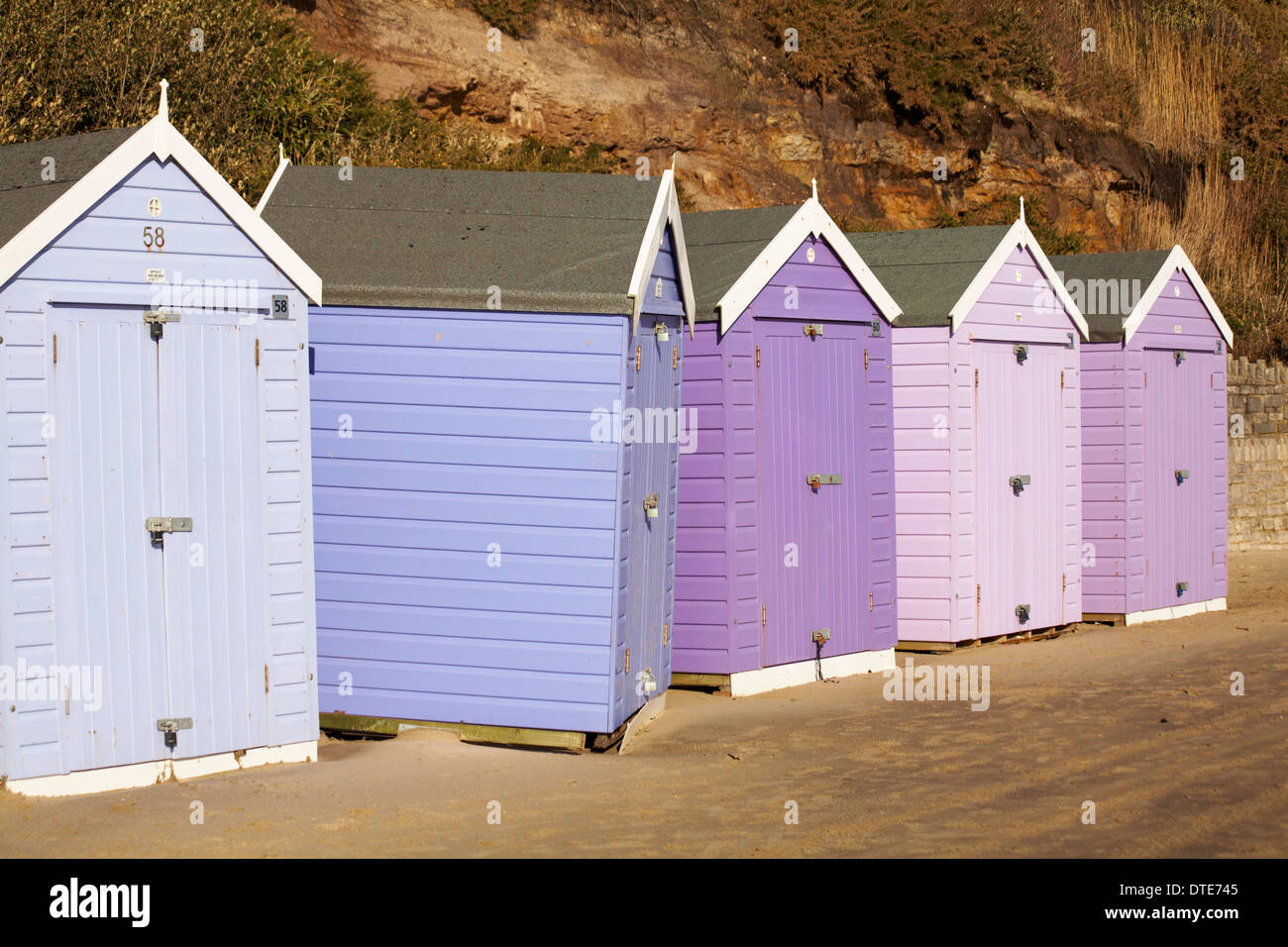 dislodged blue and purple beach huts facing the wrong way and out of ...
