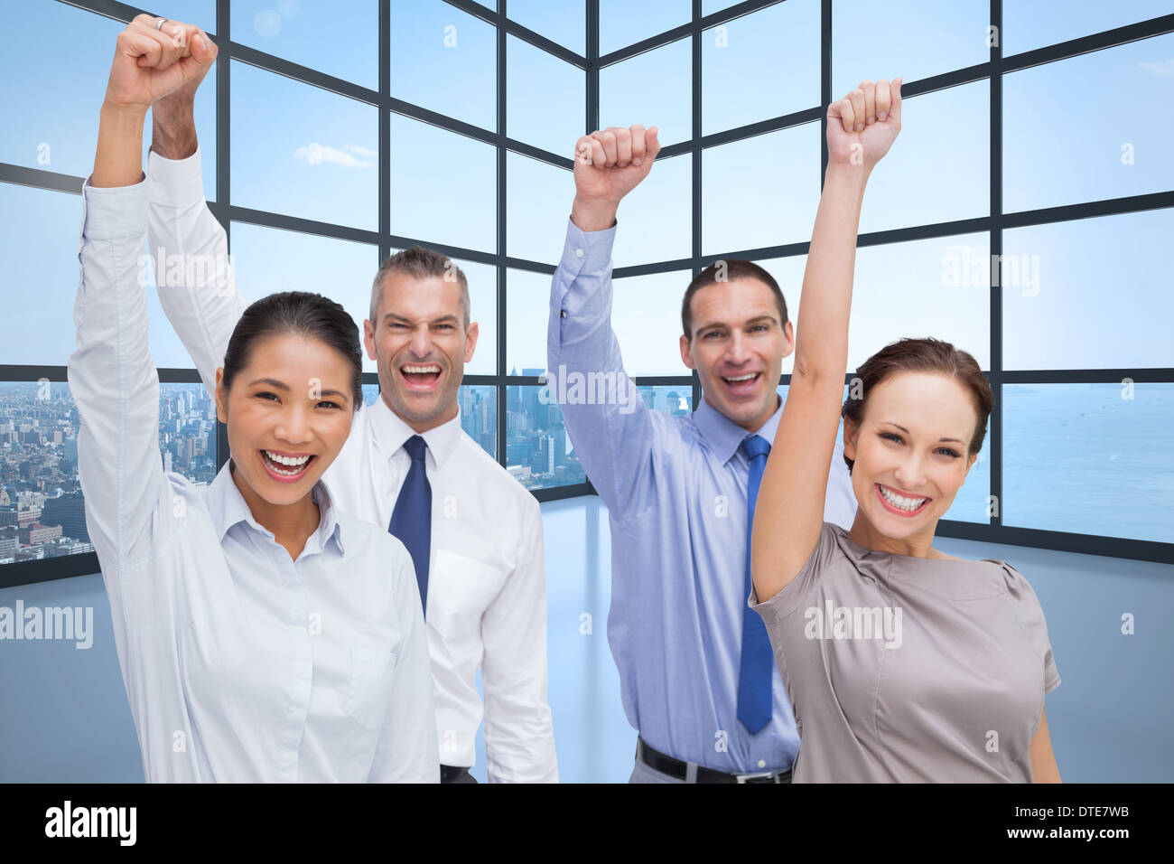 Composite image of cheerful work team posing with hands up Stock Photo ...