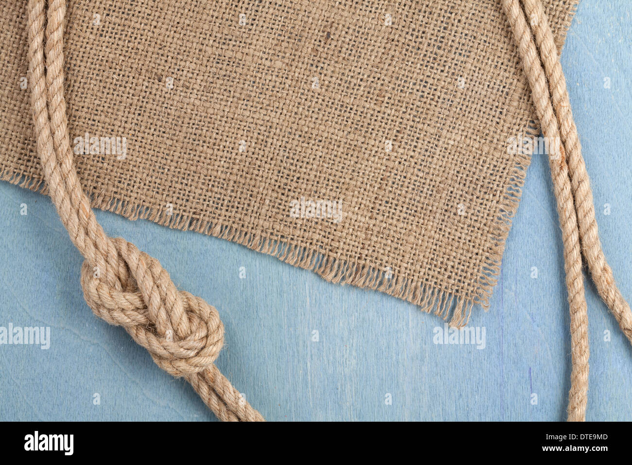 Ship rope with burlap on blue wooden texture background with copy space ...