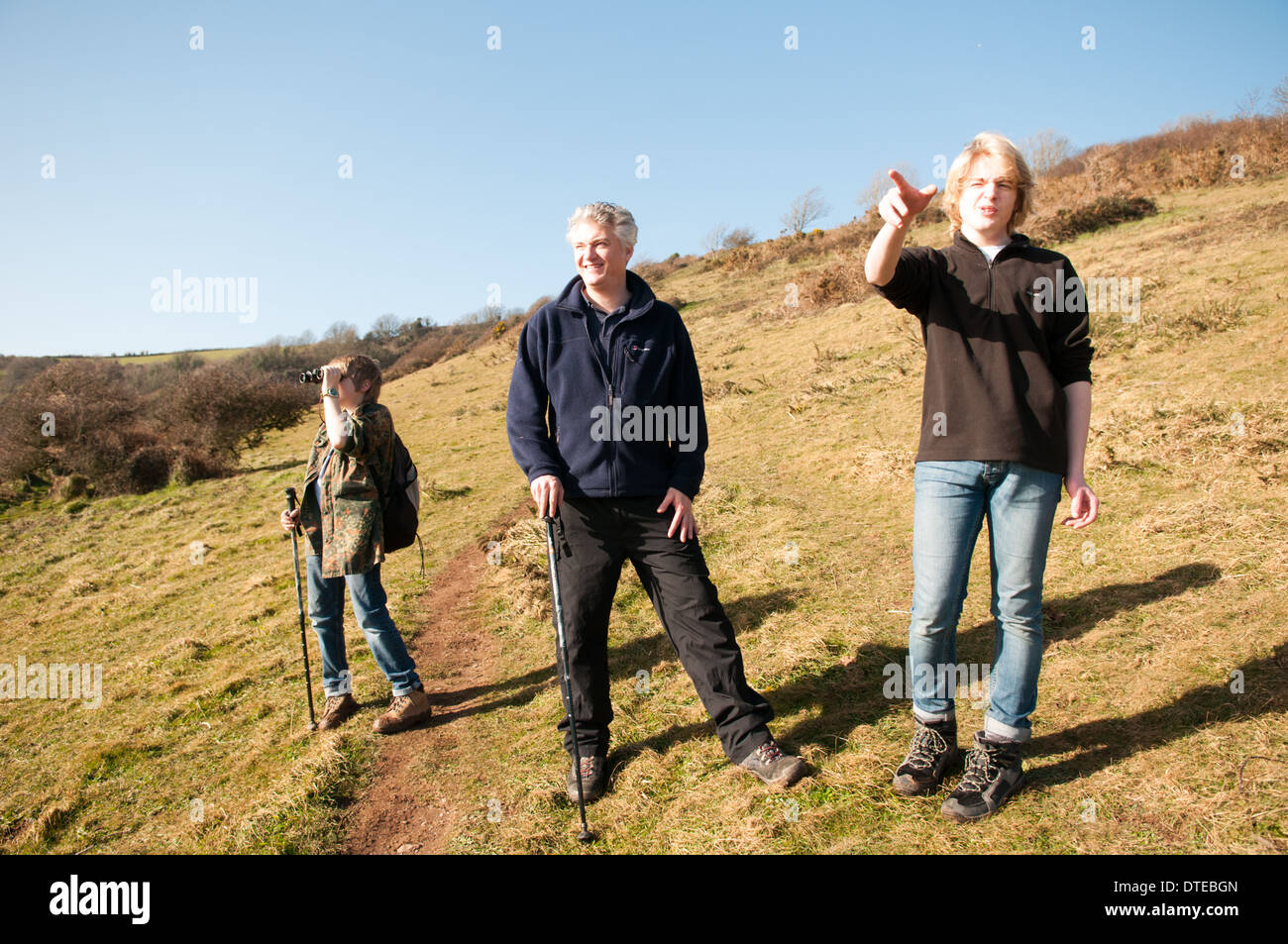 Grey-haired dad and his two teenage sons in walking boots out on a ...