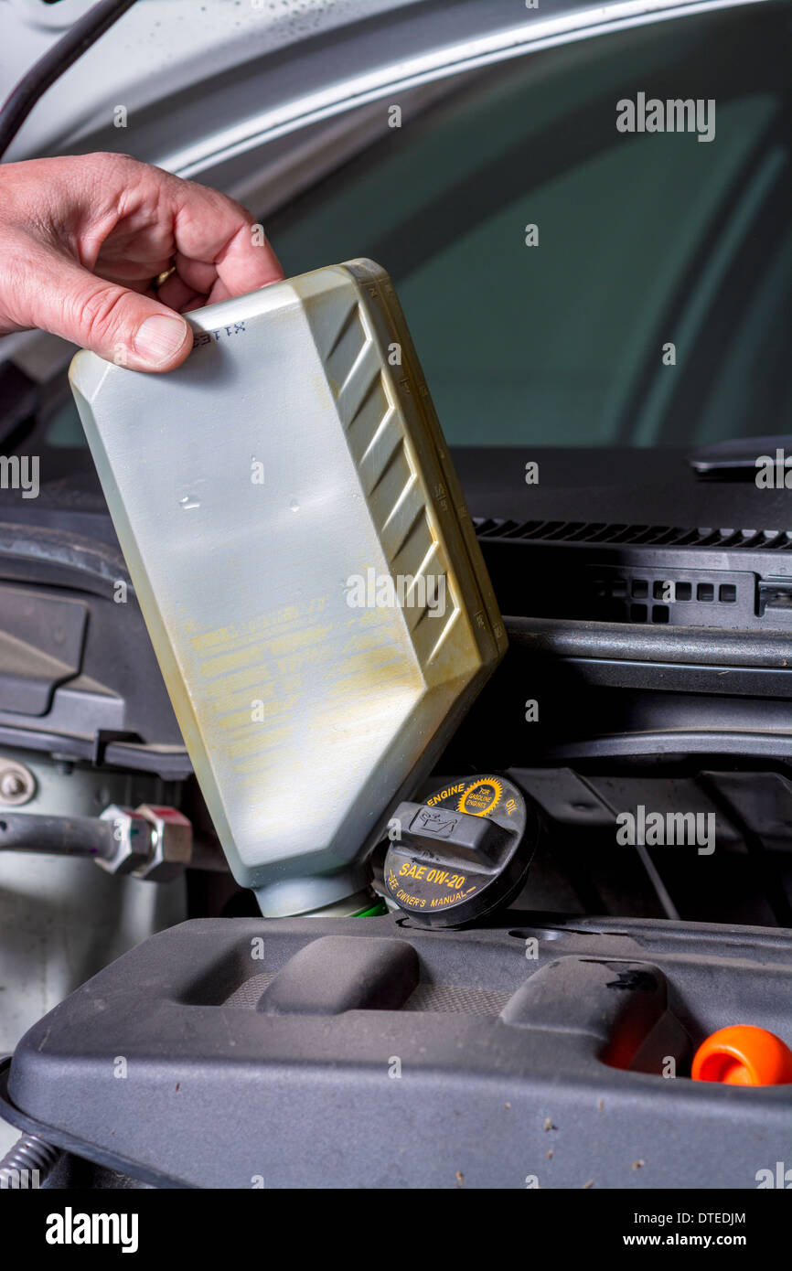 pouring oil into a car engine Stock Photo - Alamy