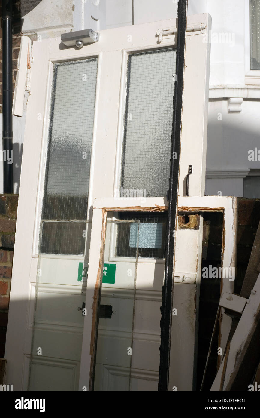 old door and frame removed as tradesman prepare a new door and frame ...