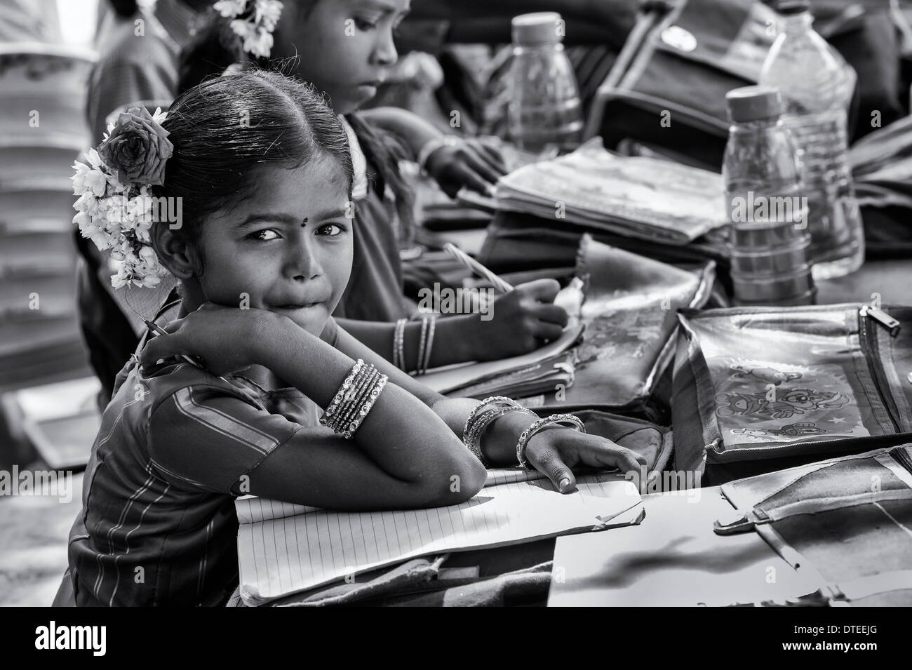 Rural Indian village school girls writing in books in an outside class ...