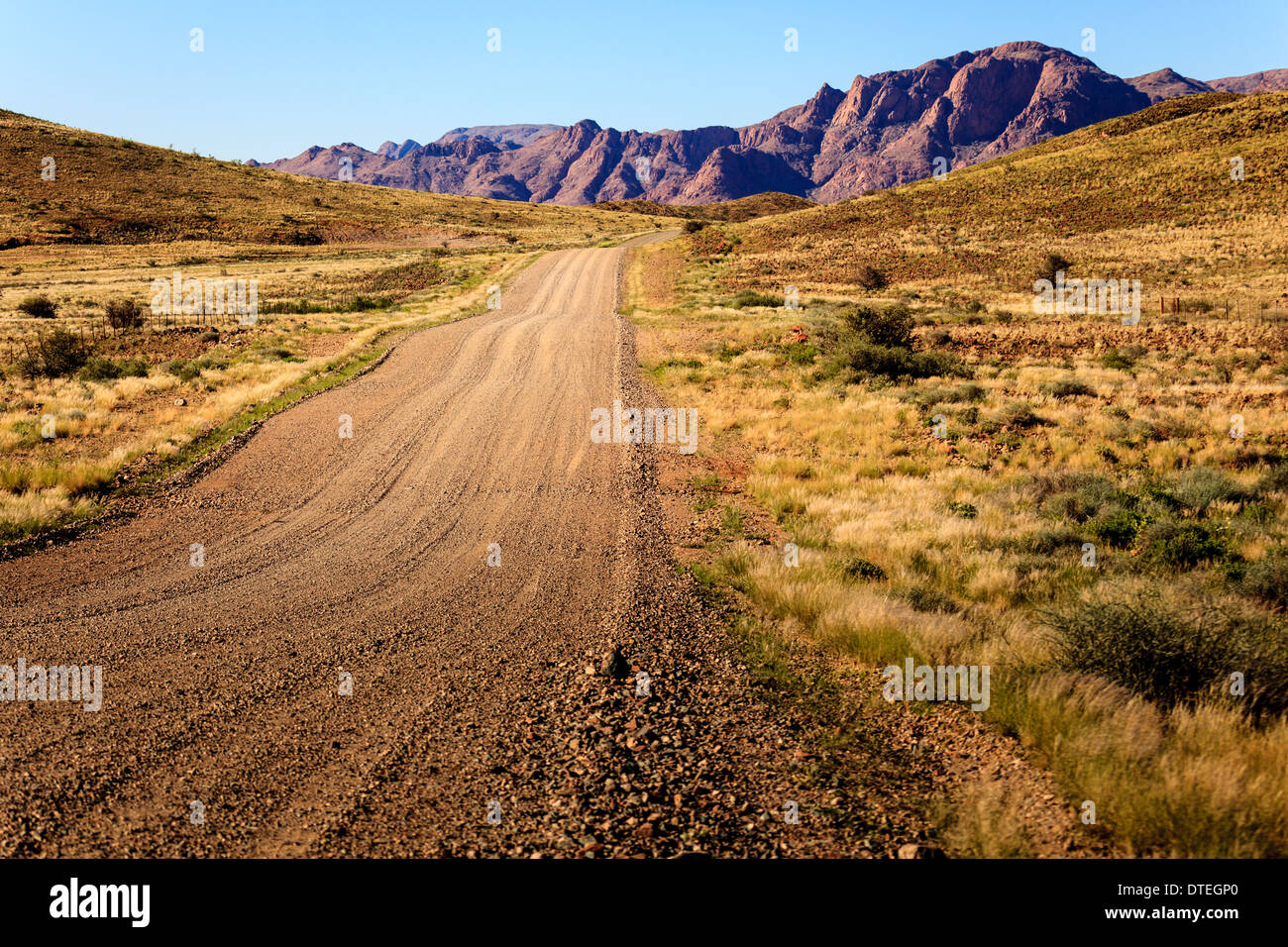 Long stretch of straight unpaved highway through the Namibian Desert in ...