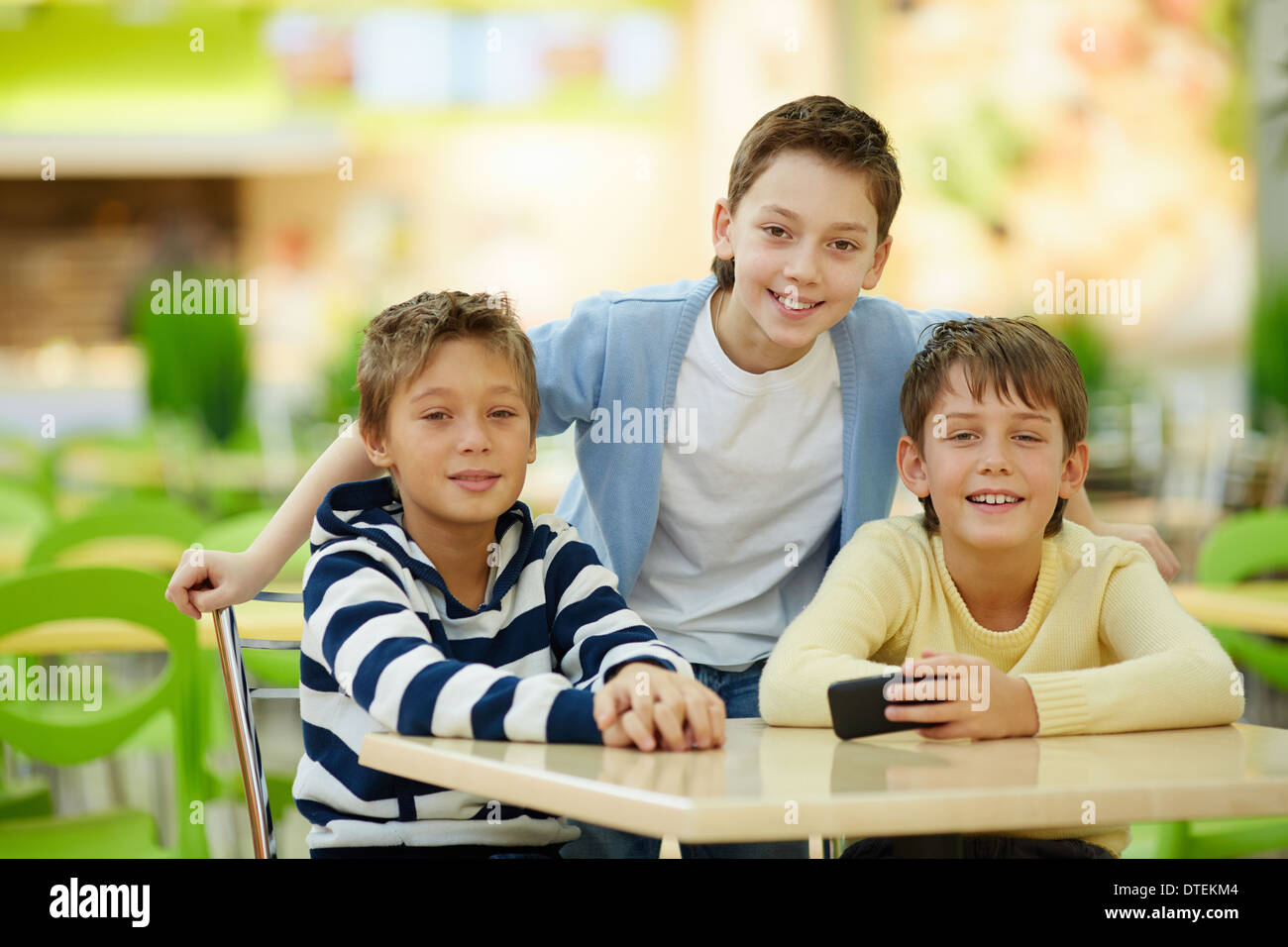 Portrait of three boyfriends at cafe table Stock Photo - Alamy