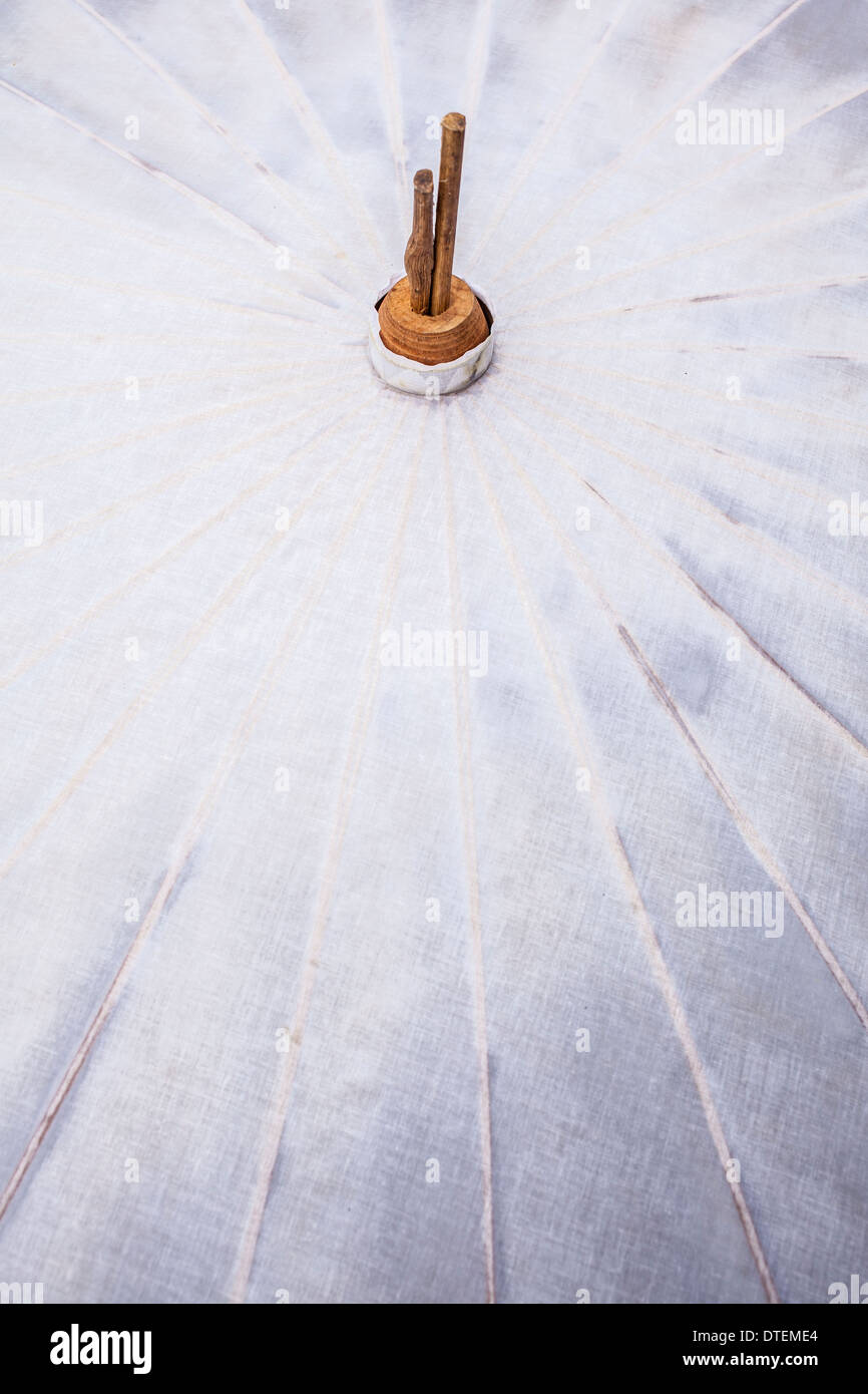 handmade umbrella, white handmade umbrella exposing sunlight in process ...