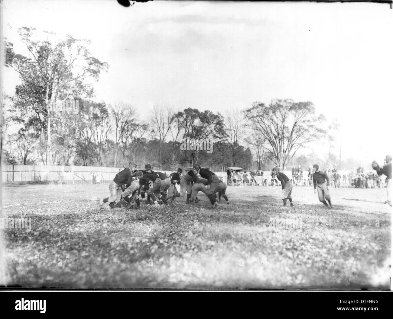 This 1910 photograph shows the action during a football game between ...