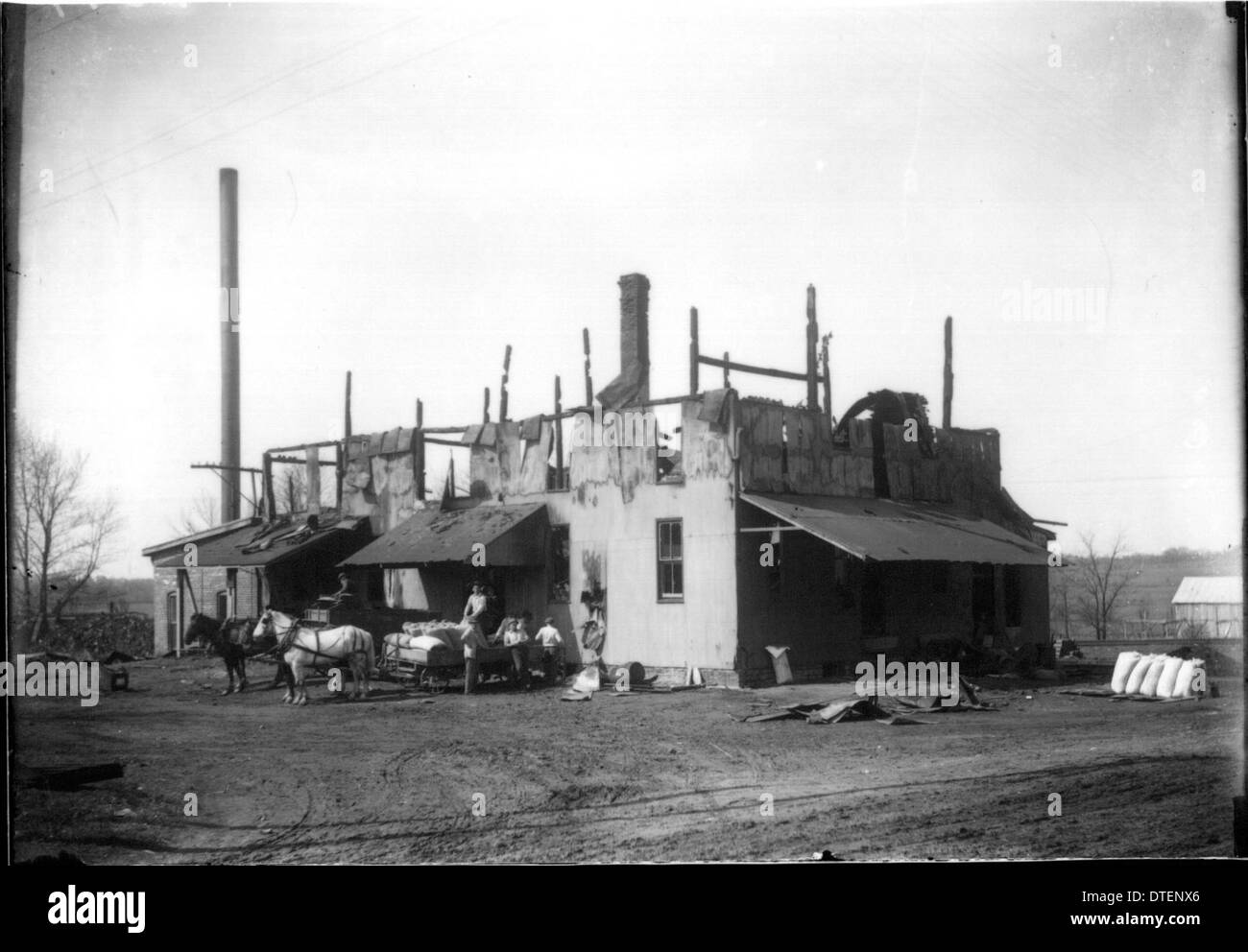 The photograph captures the aftermath of a fire at a flour mill in 1912 ...