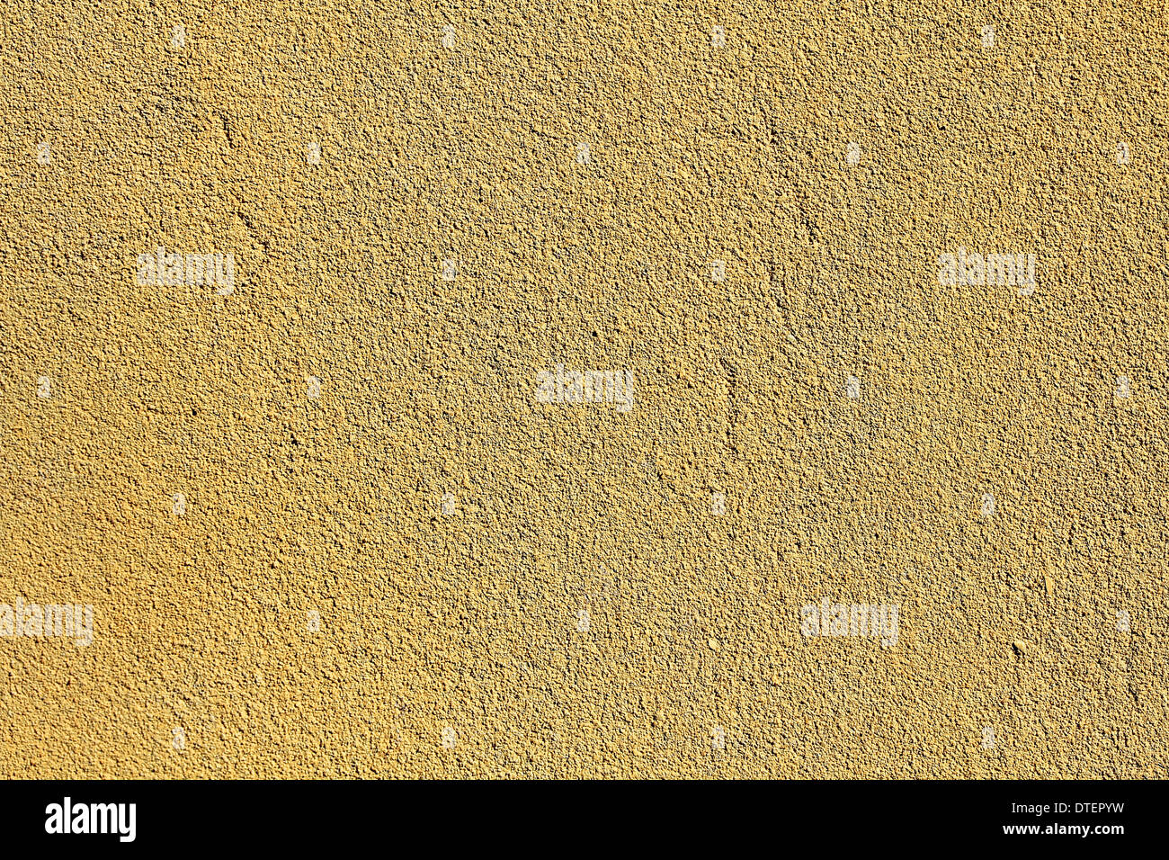 Bumpy surface of the facade of the house as a nice yellow background ...