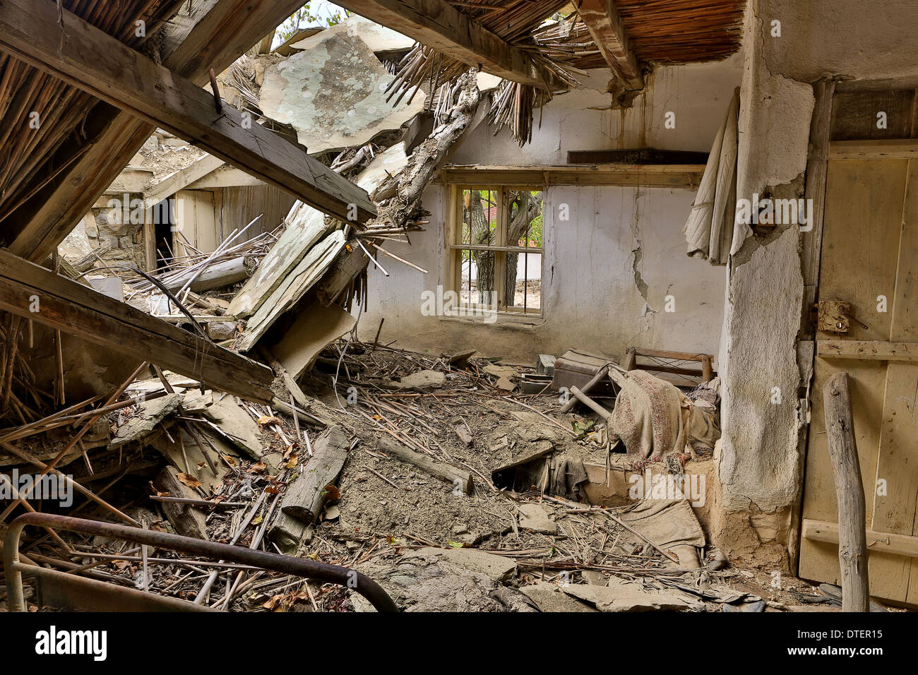 Collapsed roof in an abandoned derelict house in an old village in ...