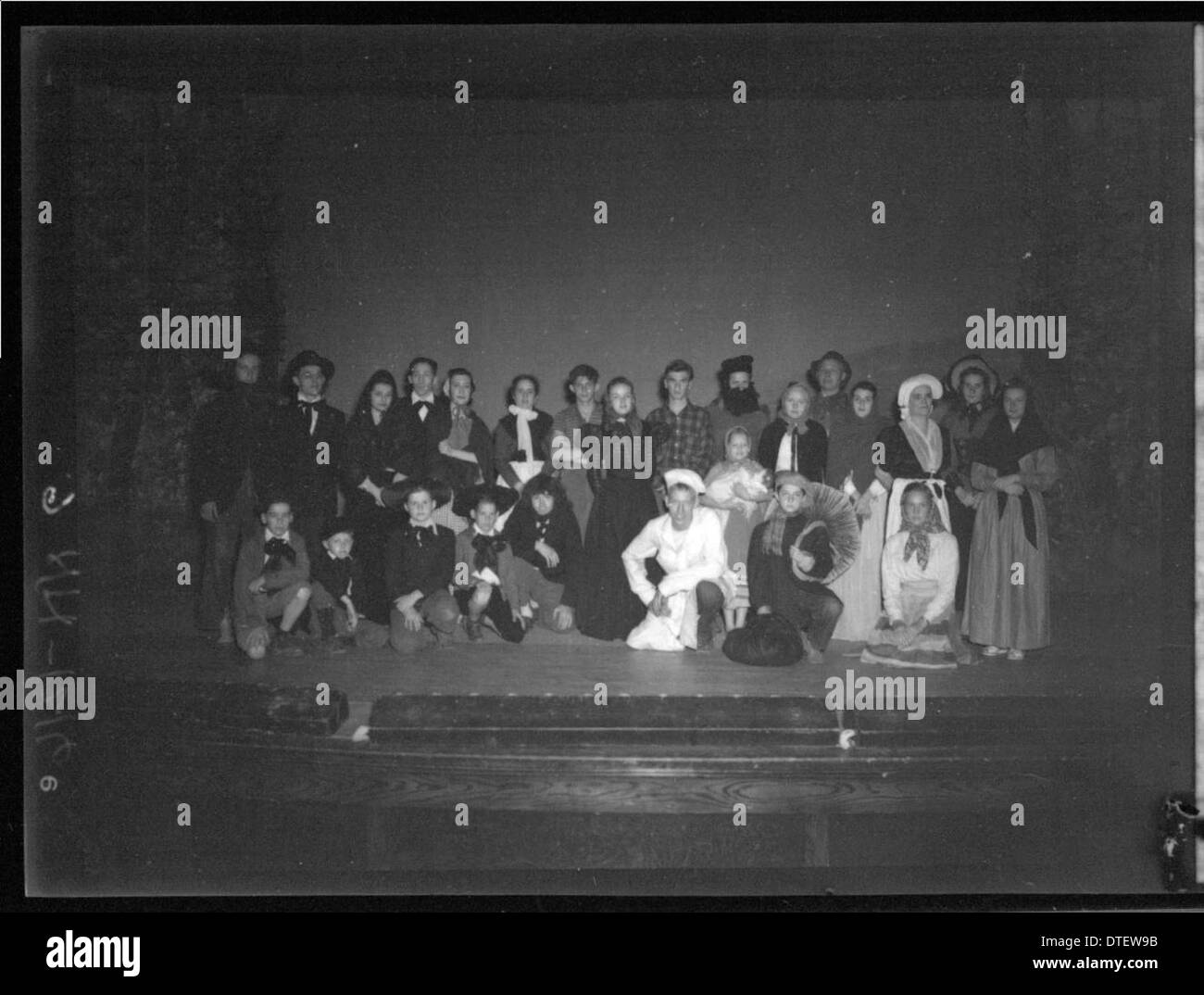 A group portrait of a theatre troupe in costume. The photograph ...