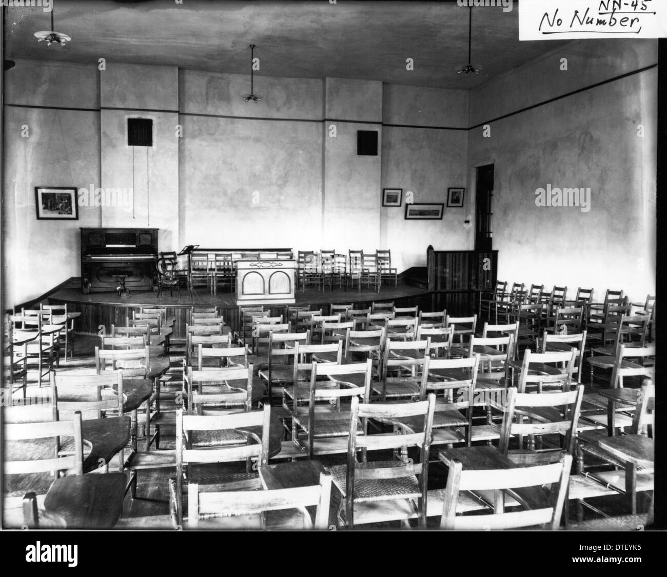 This interior photograph of an auditorium shows the desks, furniture ...