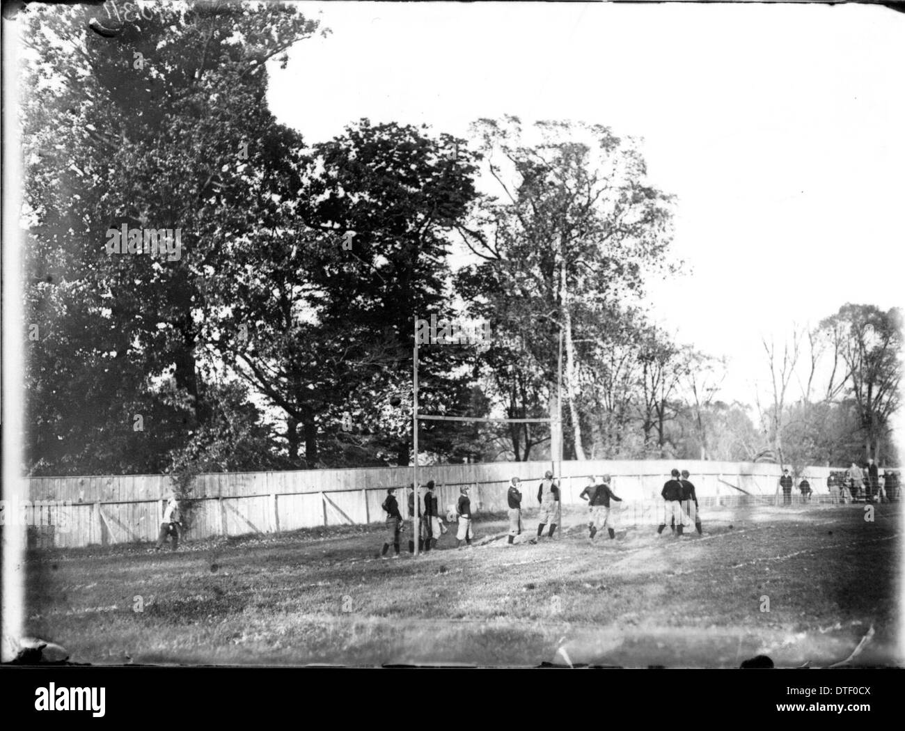 This 1910 photograph depicts a tense moment from a football game ...